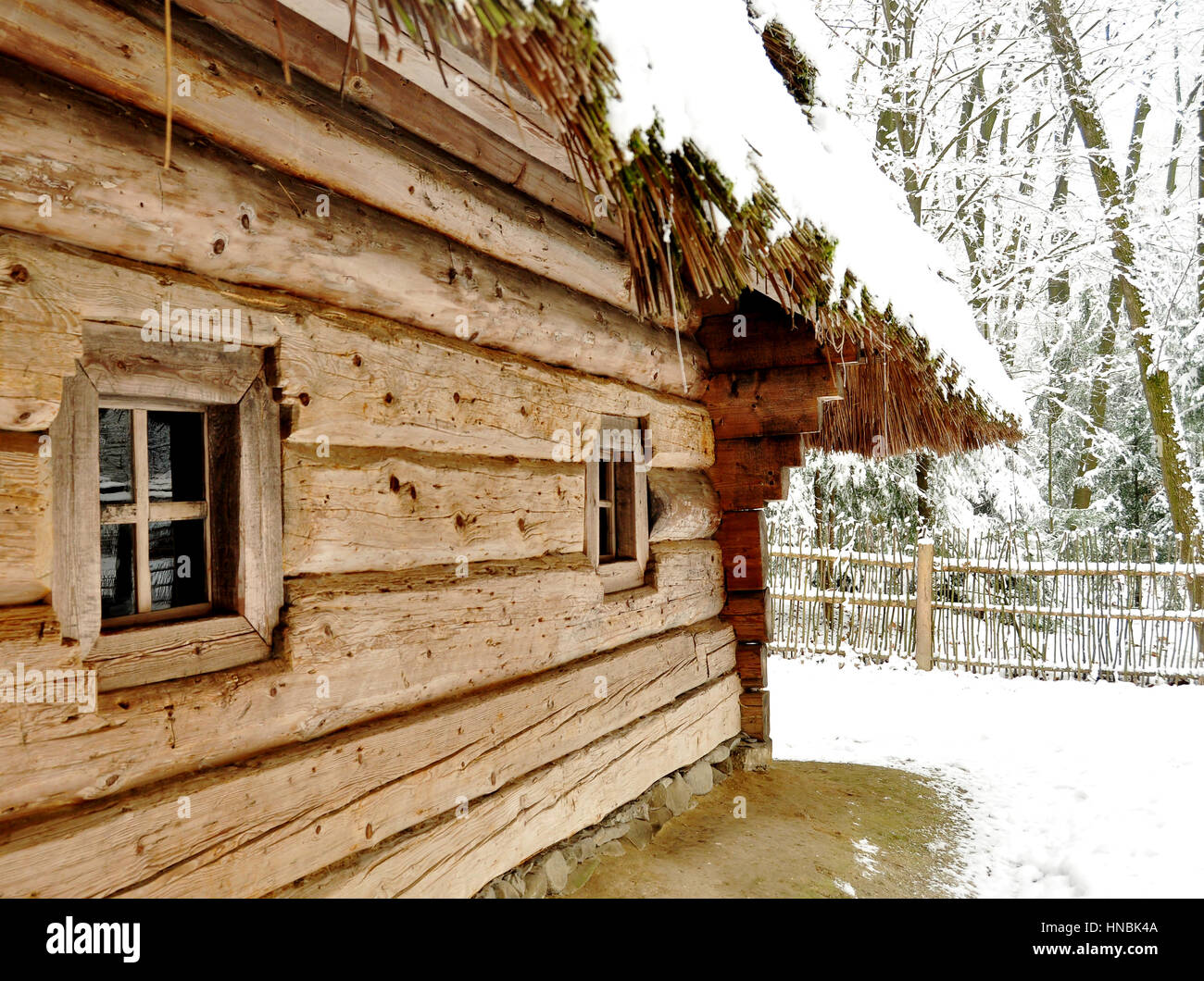 A wall with small windows of an old wooden village hut close up Stock ...