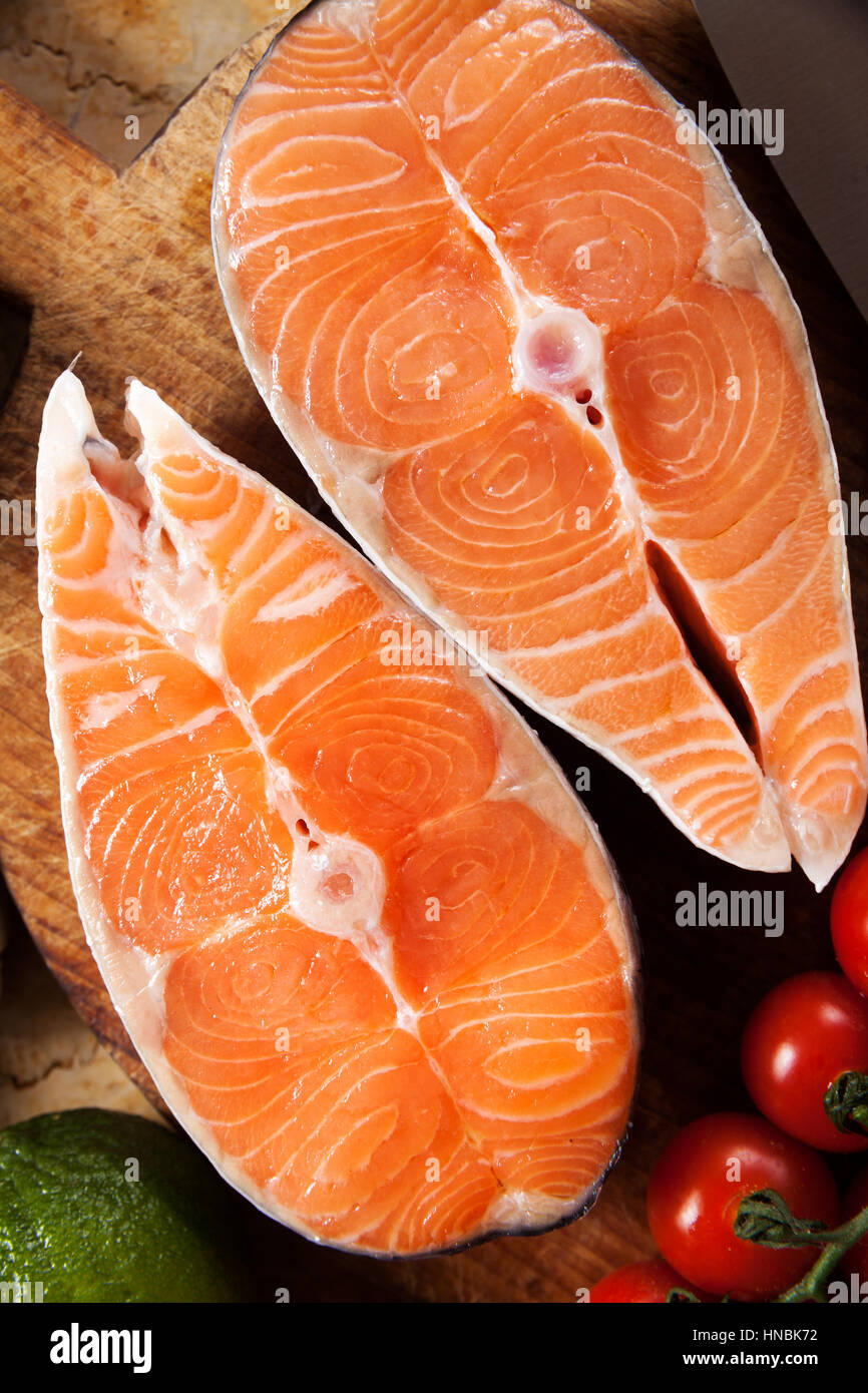 Two fresh raw salmon steaks with tomatoes on marble table Stock Photo ...