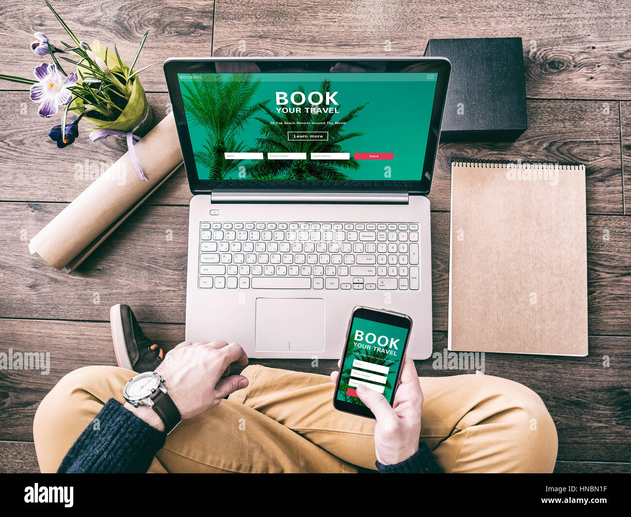 Man using a laptop and smartphone for booking hotel online. Tour ...