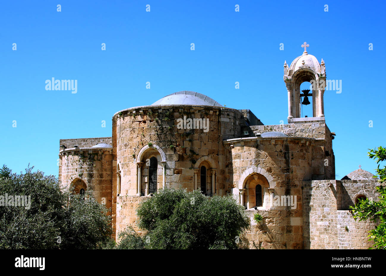 Historical stone church in Byblos, Lebanon features arches and ornate ...