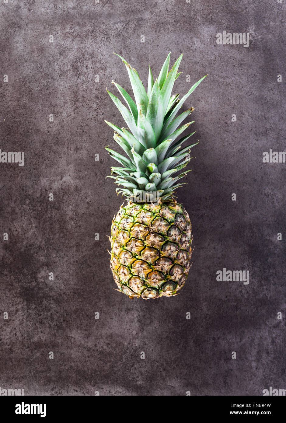 ripe pineapple on a stone background Stock Photo - Alamy