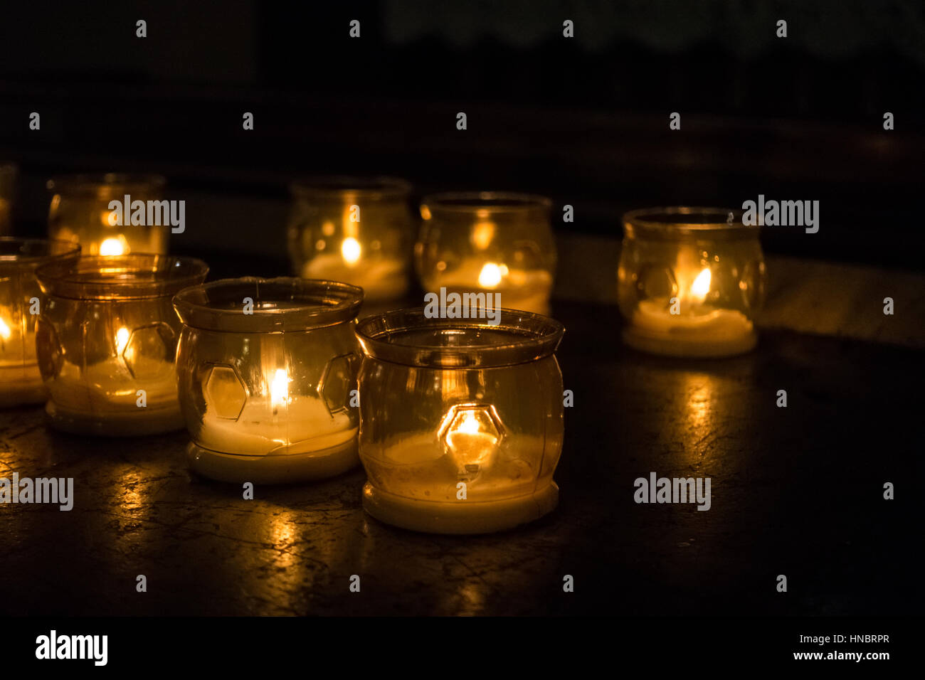 Holy candles in a dark ambient Stock Photo - Alamy