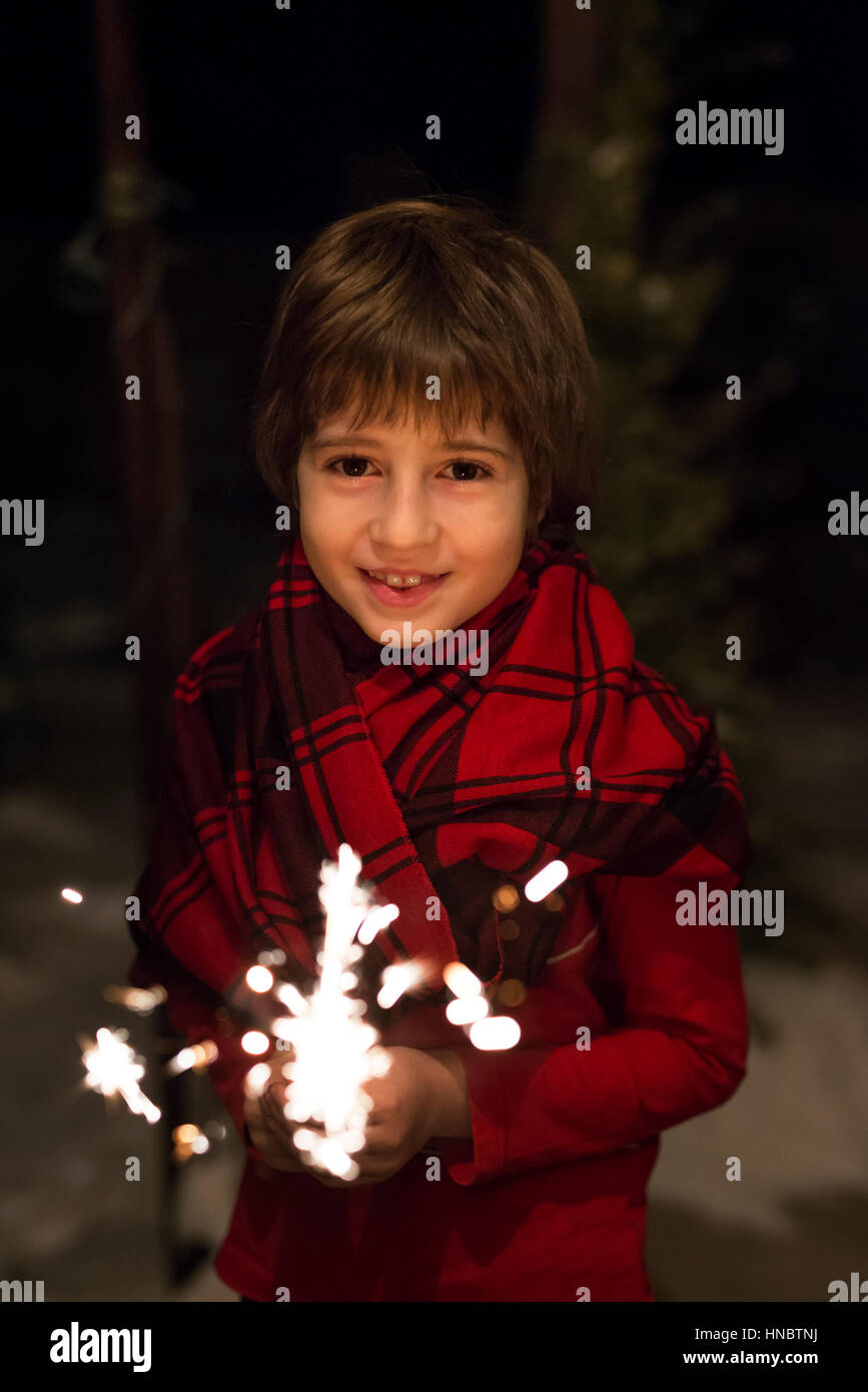 Boy holding a sparkler Stock Photo - Alamy