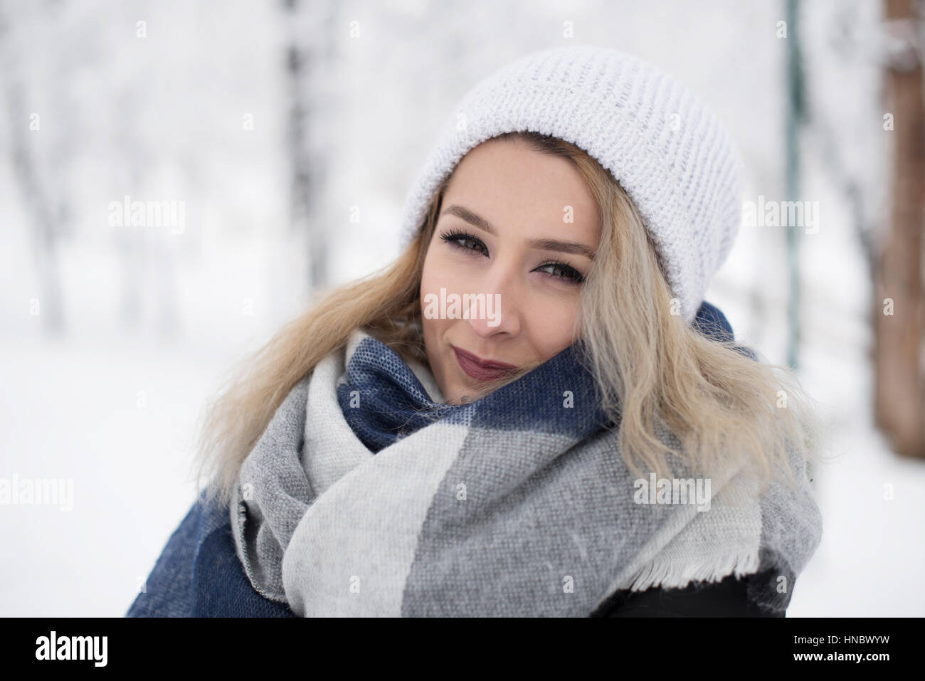 Portrait of a woman in snow in hat and scarf Stock Photo - Alamy