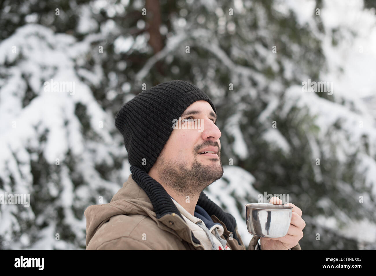 Man drinking cup of tea in the snow Stock Photo - Alamy