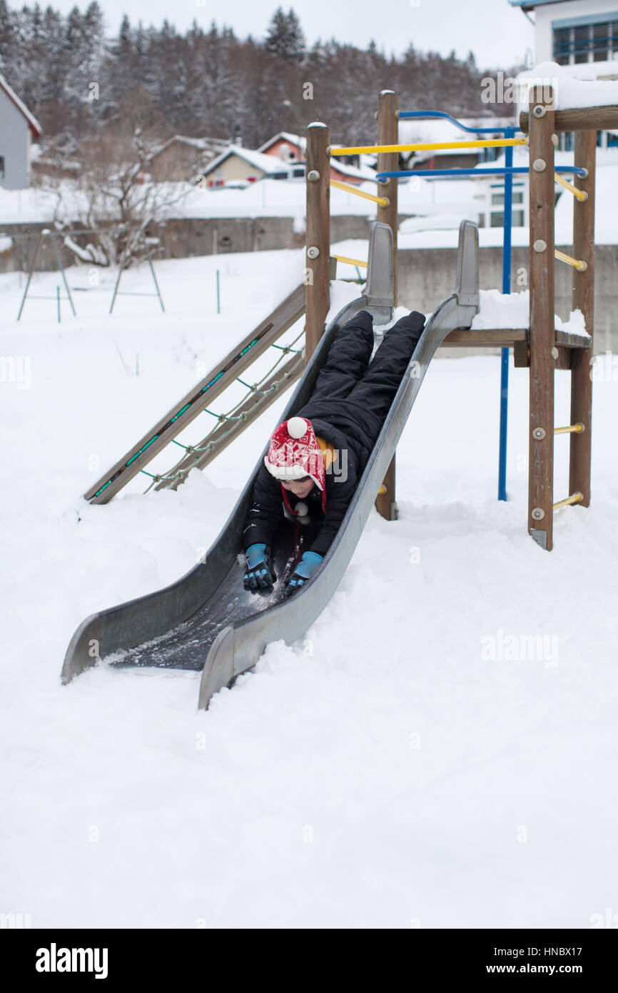 Child on slide lying down hi-res stock photography and images - Alamy