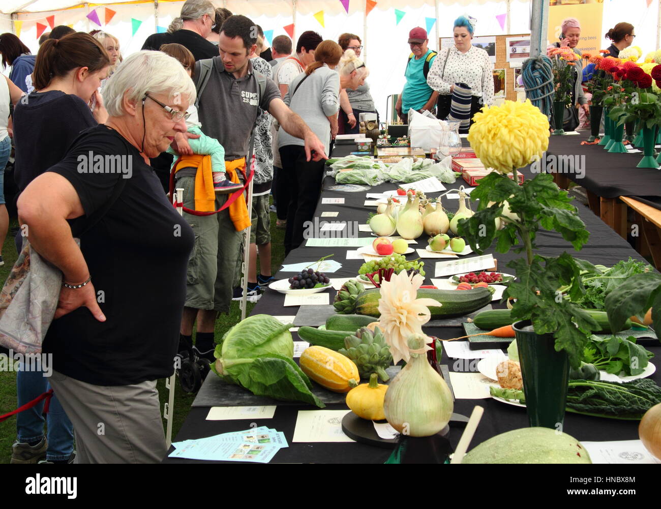 Visitors admire flower, vegetable and fruit displays at a traditional ...