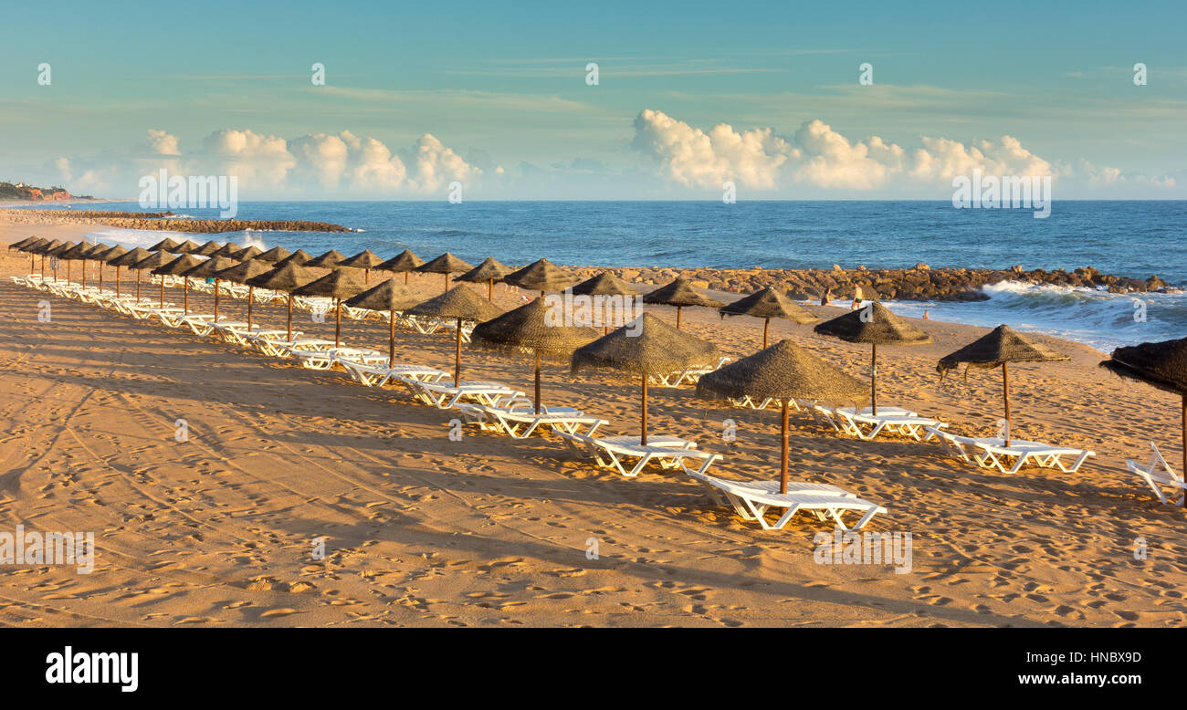 Sun loungers and parasols on the beach, Algarve, Portugal Stock Photo ...