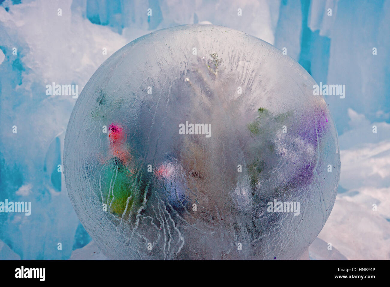 Frozen ice ball filled with colorful objects Stock Photo - Alamy