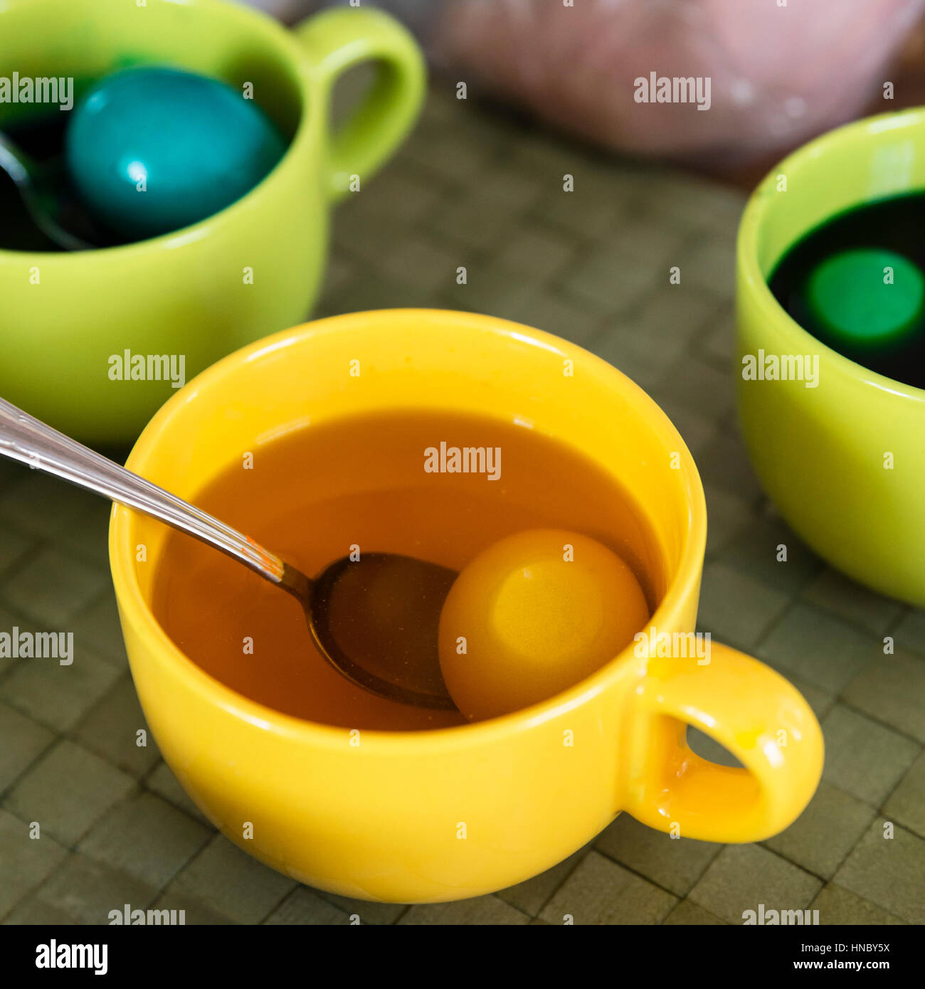 Cups with eggs and colored dye for Easter Stock Photo - Alamy