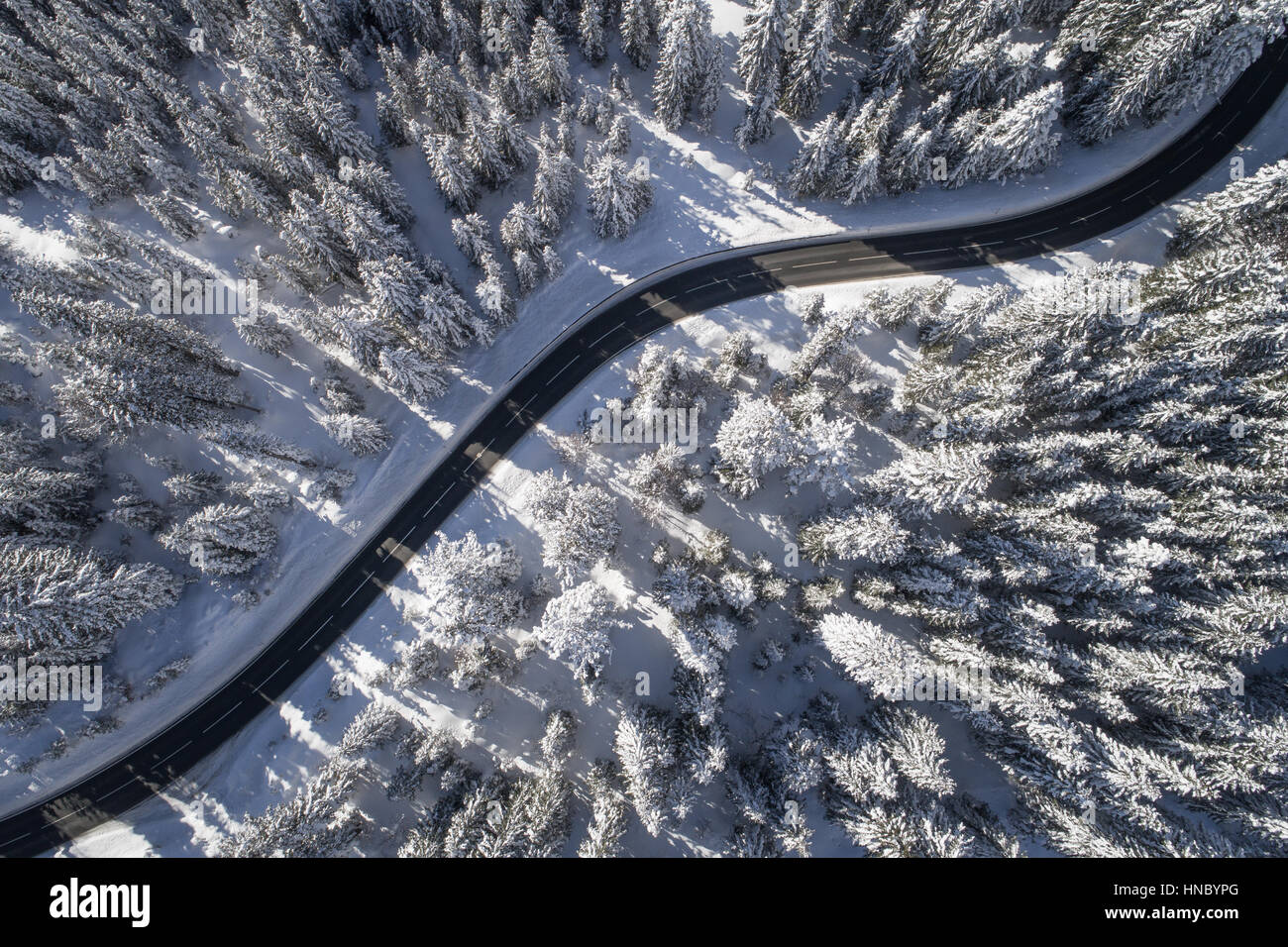 Aerial view of a road winding through a winter landscape, Salzburg ...