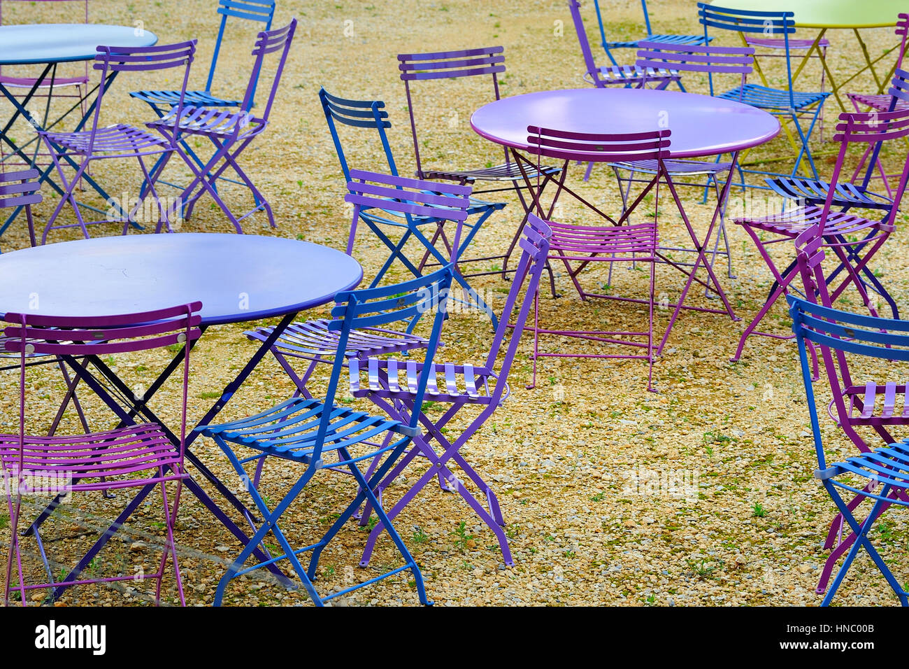Colored tables in garden Stock Photo - Alamy