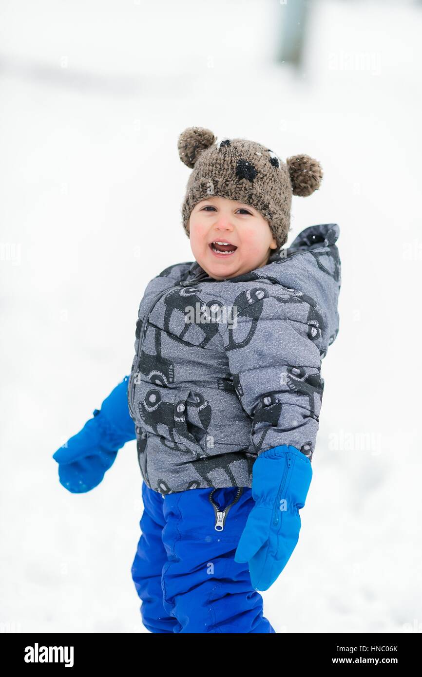 Boy in warm clothing in the snow Stock Photo - Alamy