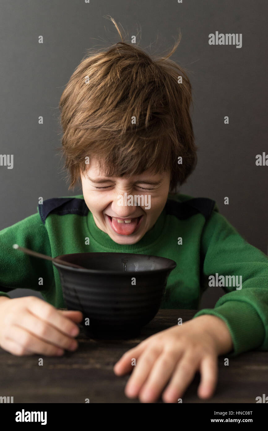 Boy grimacing at a bowl of food Stock Photo - Alamy