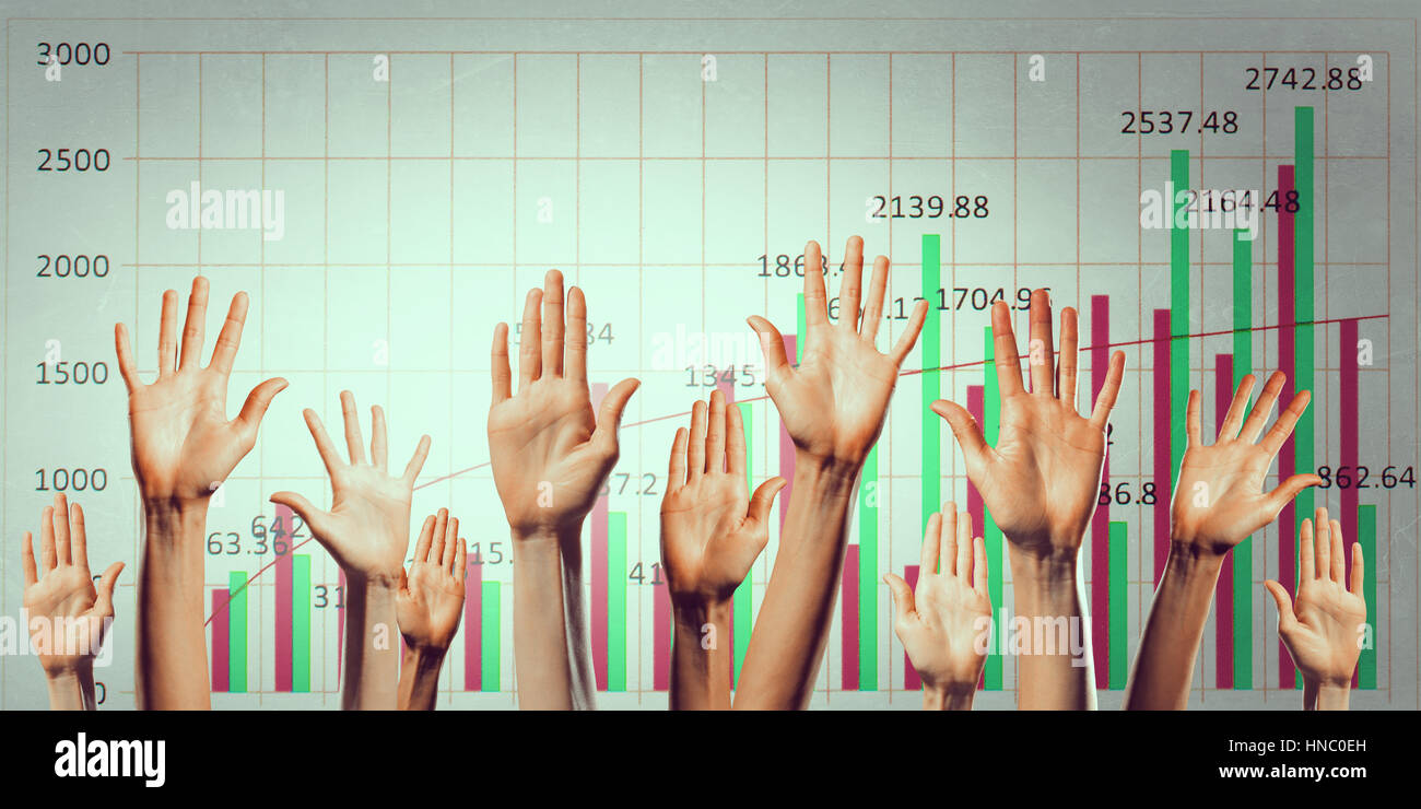 Row of raised hands showing different gestures and graphs at background ...