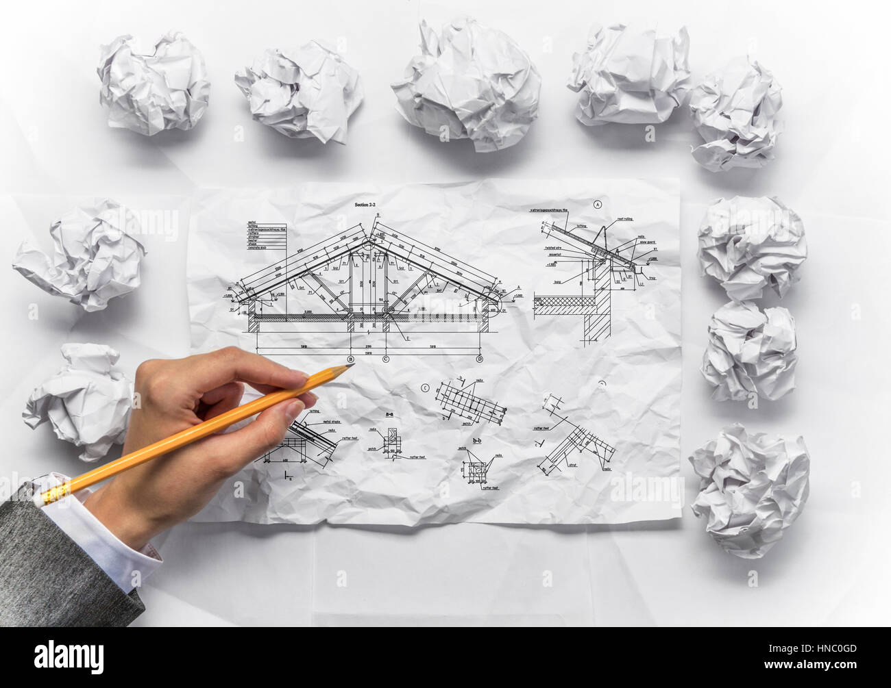 Hand of businesswoman drawing buildings on crumpled paper Stock Photo ...
