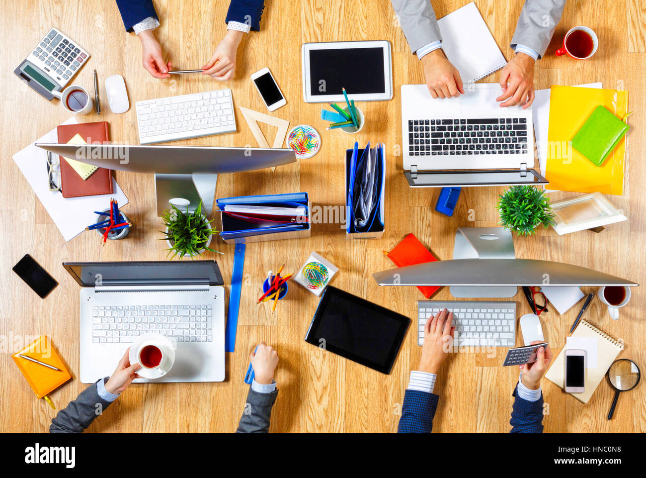 Top view of office table with four colleagues working together Stock ...