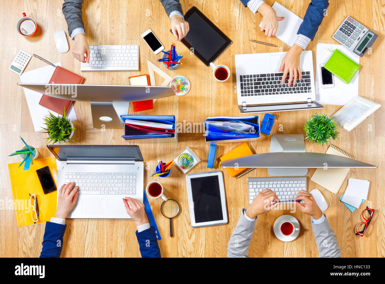 Top view of office table with four colleagues working together Stock ...