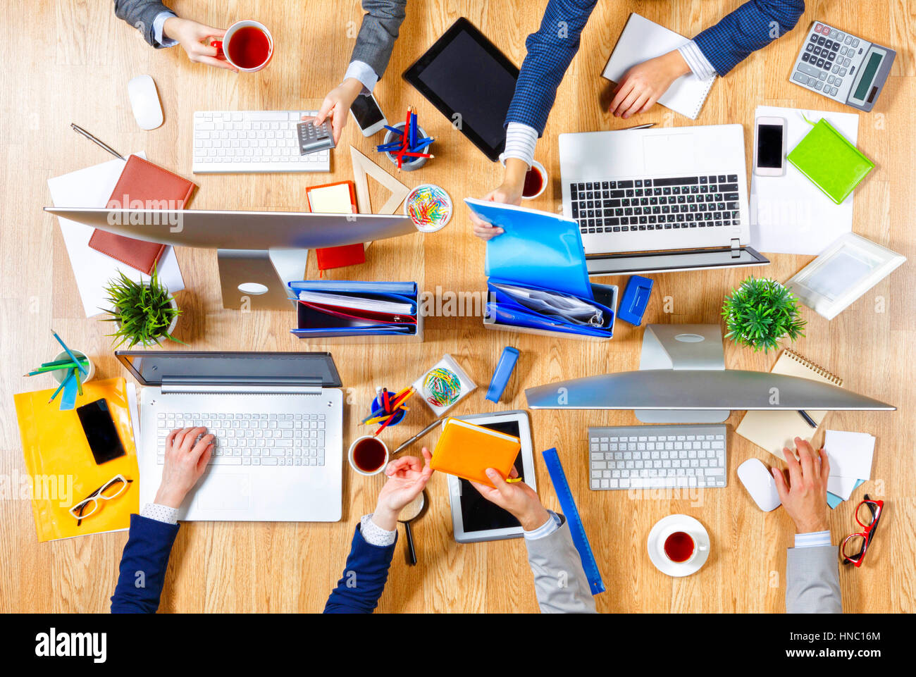Top view of office table with four colleagues working together Stock ...