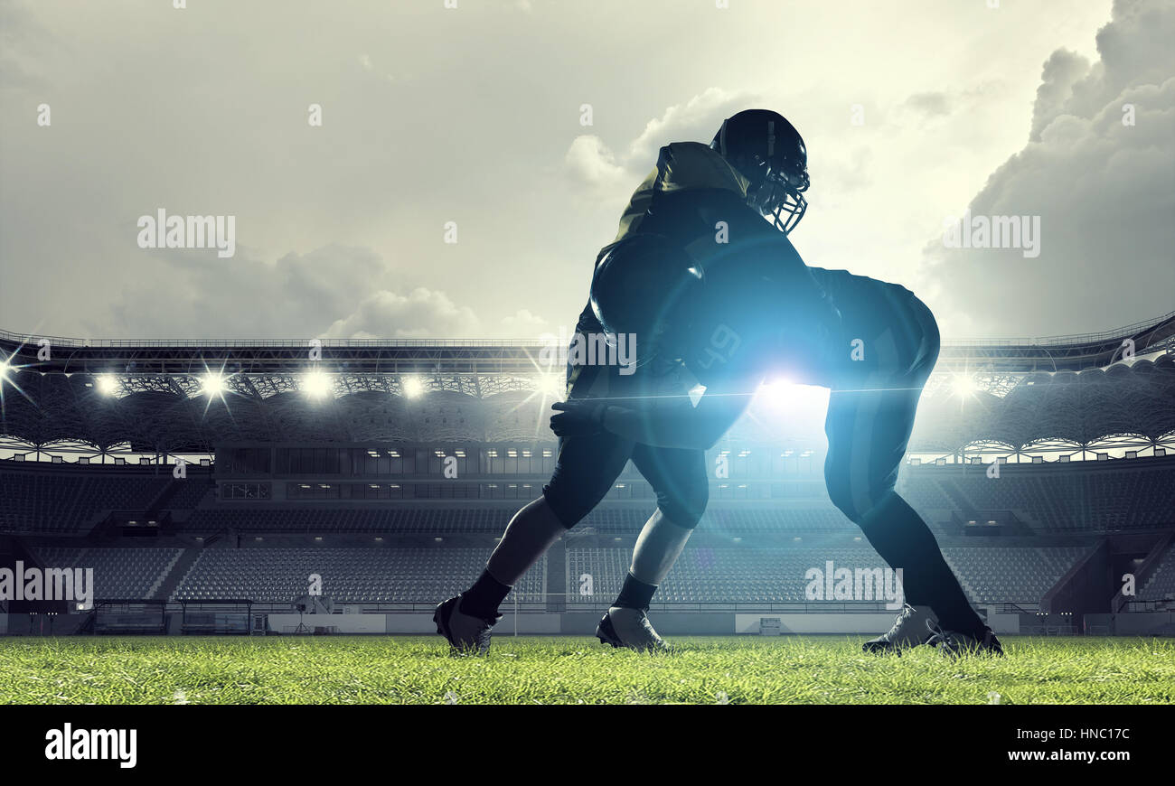 Two american football players fighting for ball. Mixed media Stock ...