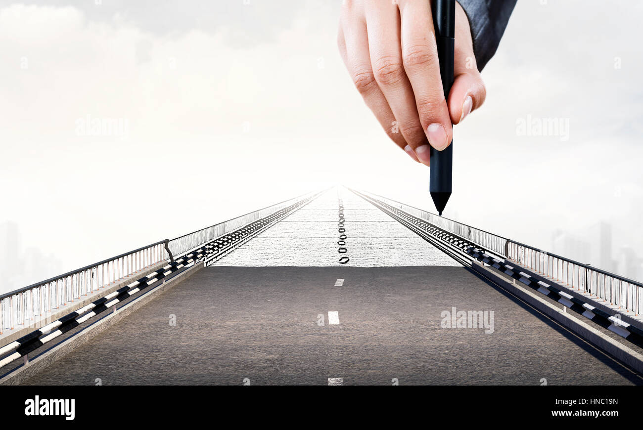 Hand of female drawing elements of crashed bridge Stock Photo - Alamy