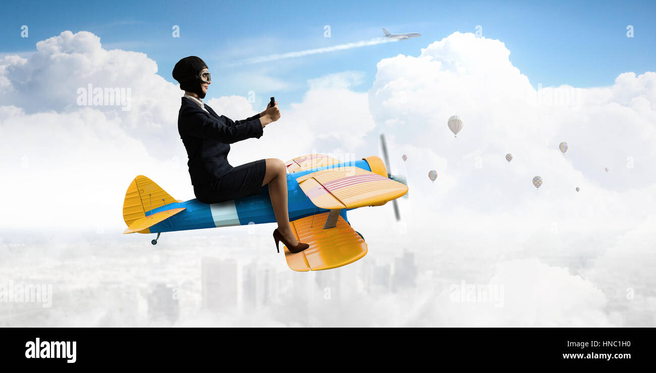 Woman pilot in helmet flying old styled airplane Stock Photo - Alamy