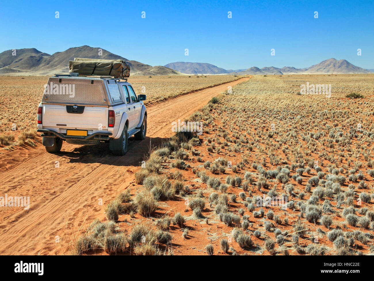 Pickup truck driving on desert road towards the Tiras mountains Stock ...