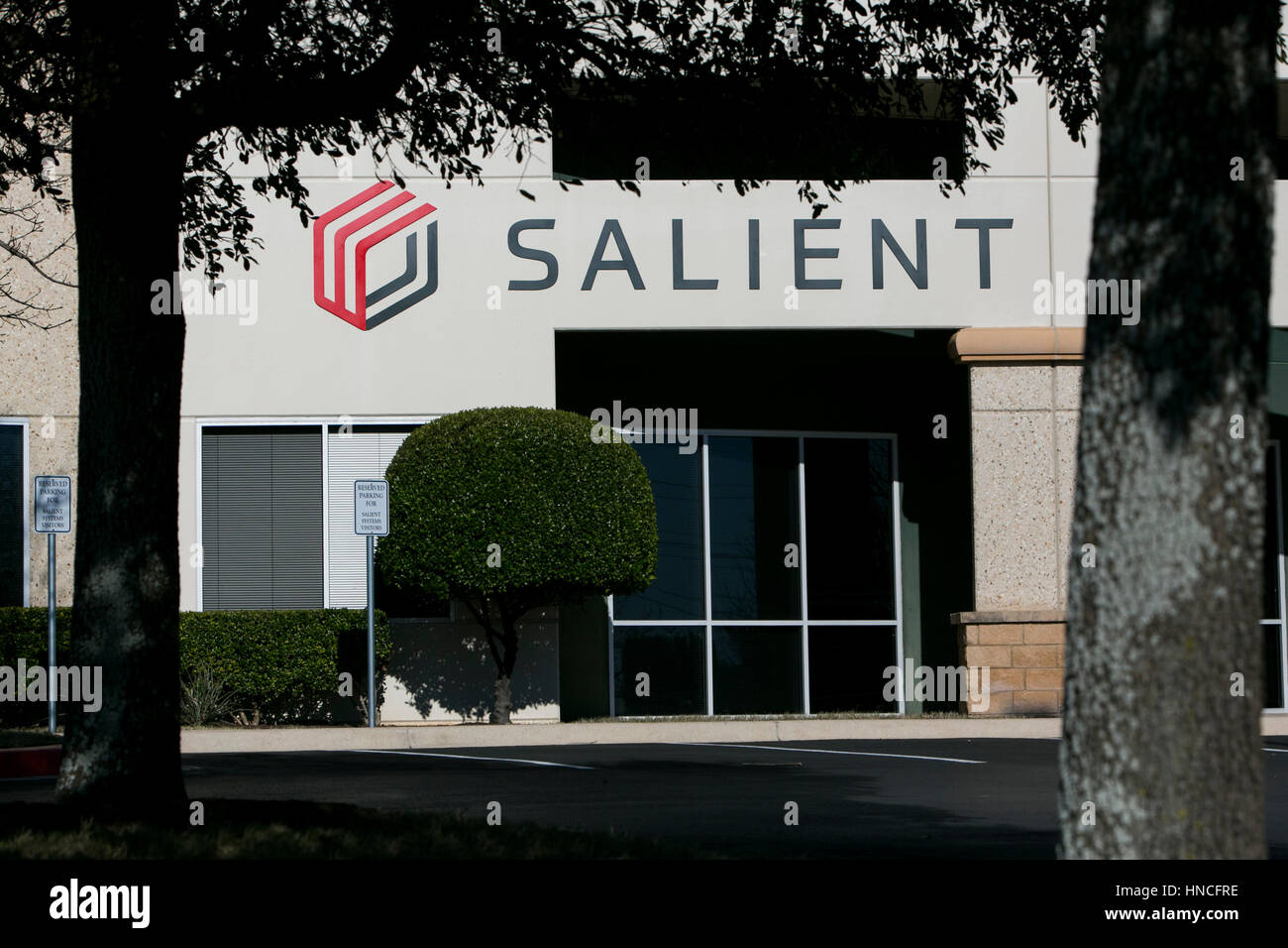 A logo sign outside of a facility occupied by Salient Systems in Austin ...