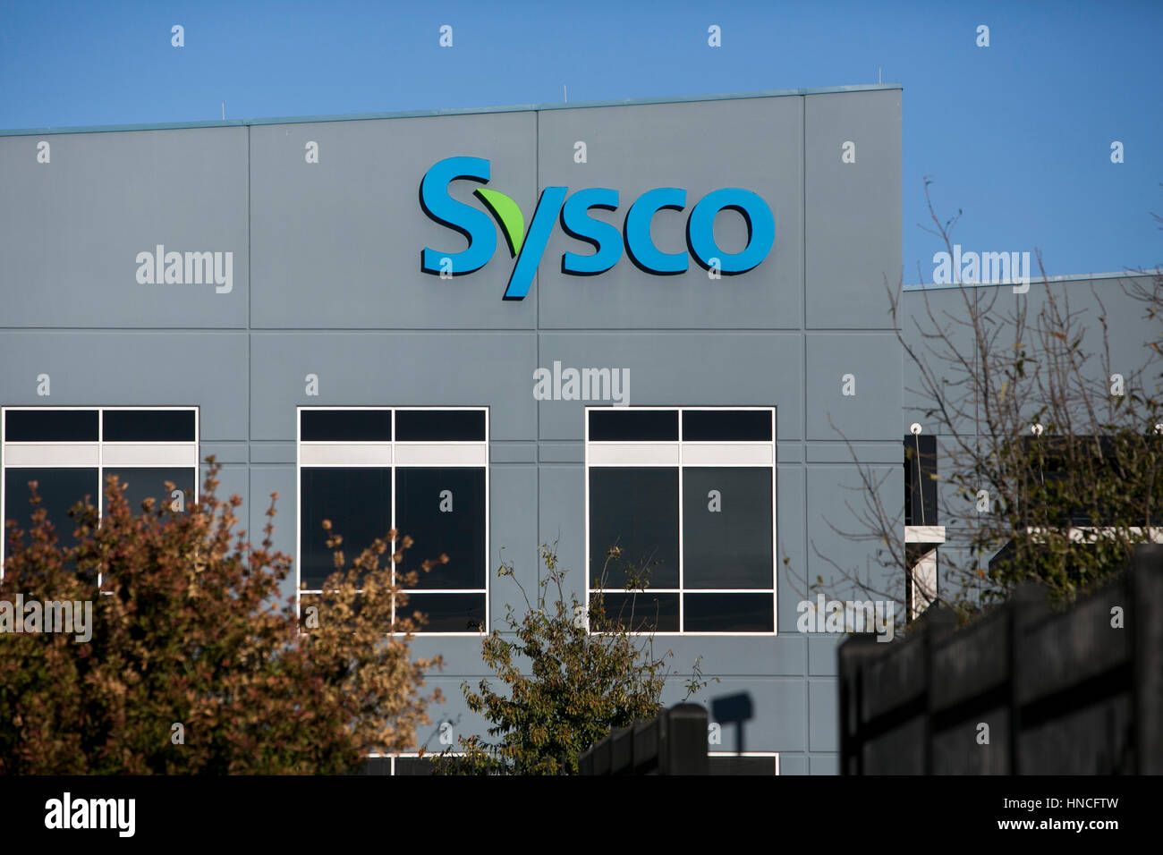 A logo sign outside of a facility occupied by the Sysco Corporation in ...
