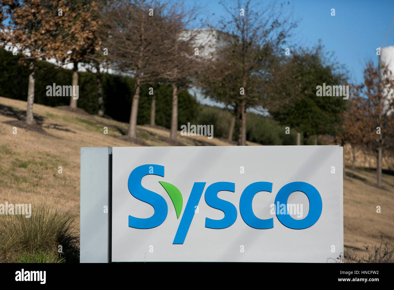 A logo sign outside of a facility occupied by the Sysco Corporation in ...