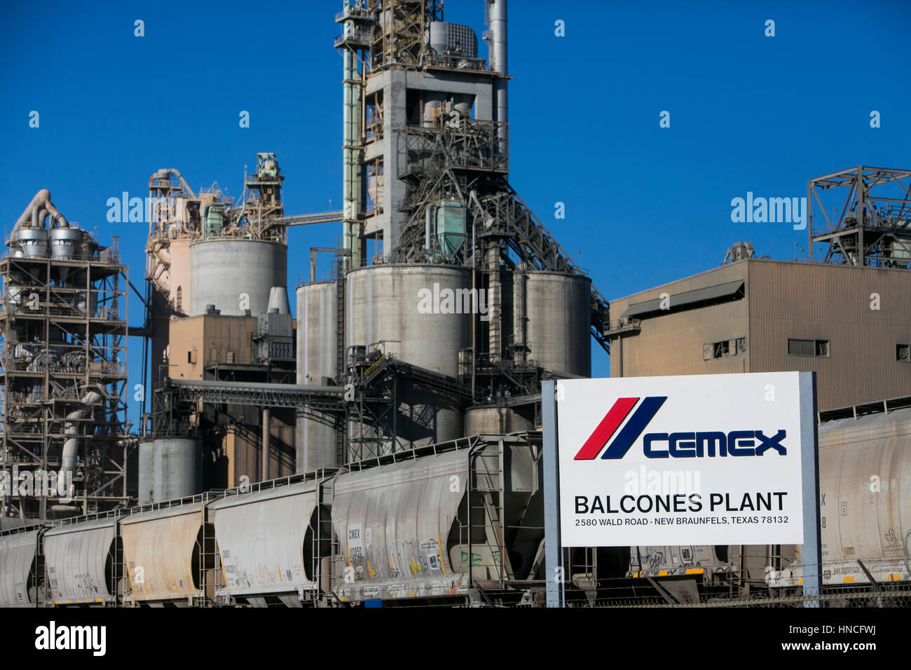 A logo sign outside of a facility occupied by Cemex in New Braunfels ...