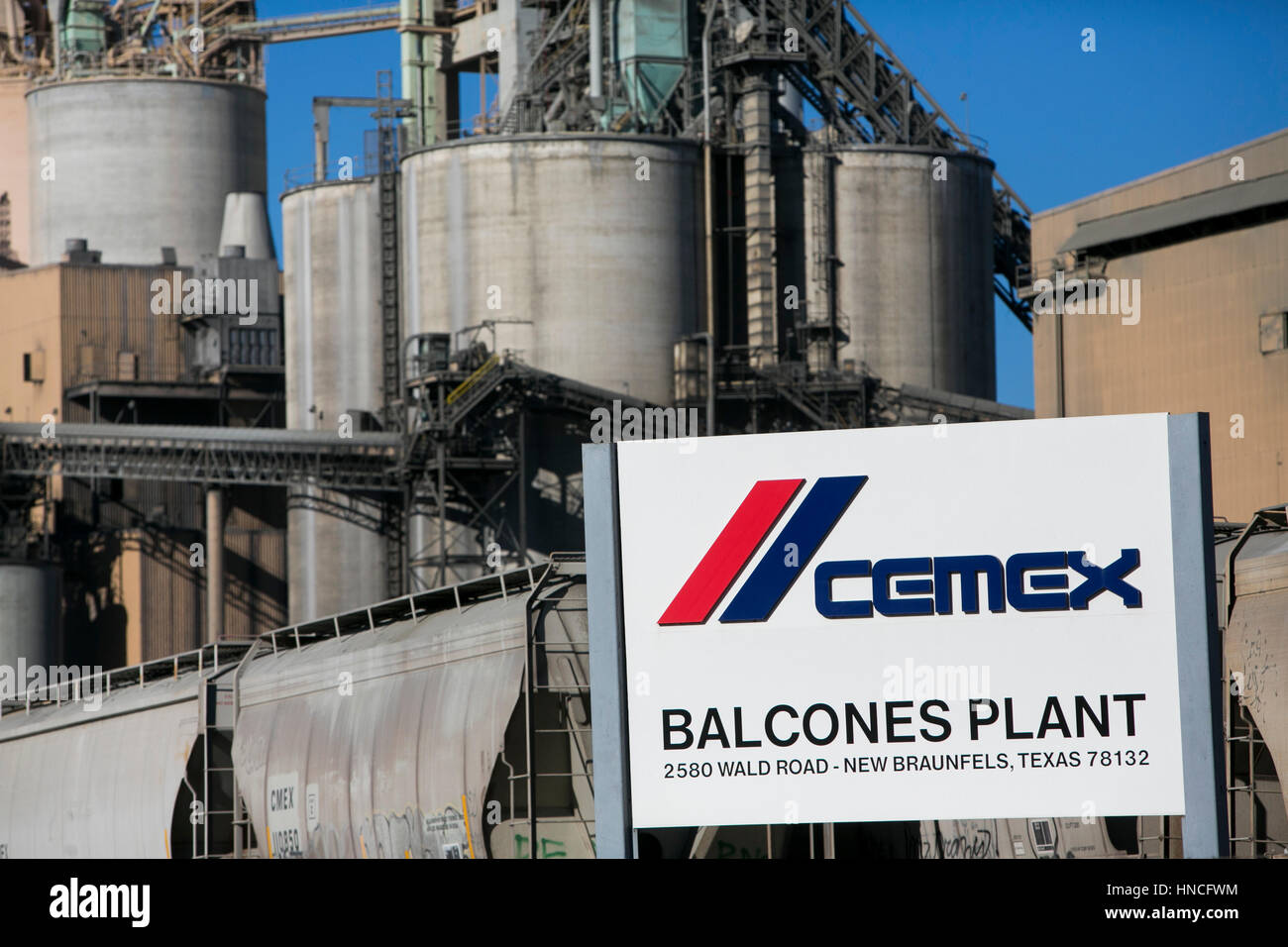 A logo sign outside of a facility occupied by Cemex in New Braunfels ...