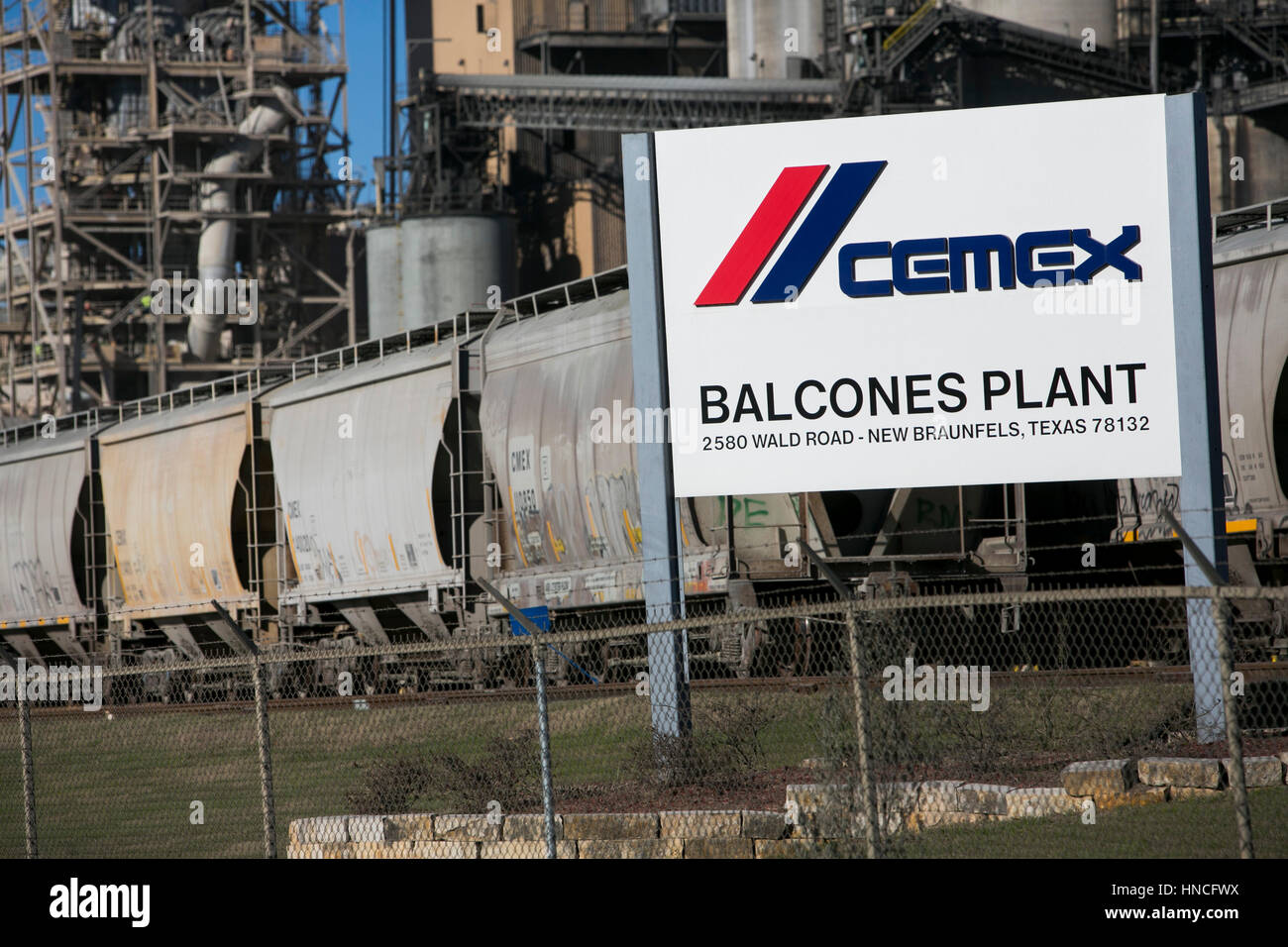 A logo sign outside of a facility occupied by Cemex in New Braunfels ...