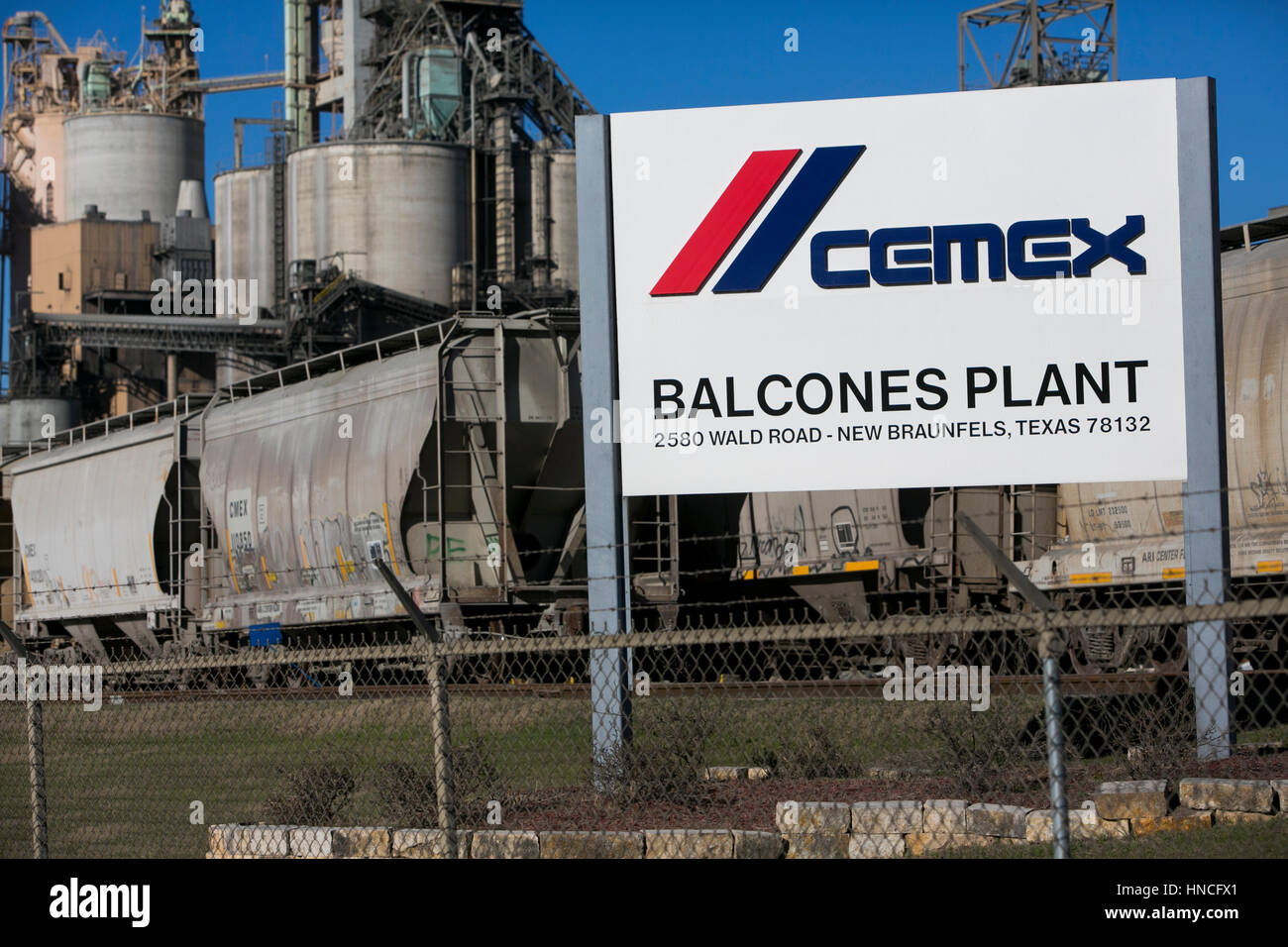 A logo sign outside of a facility occupied by Cemex in New Braunfels ...