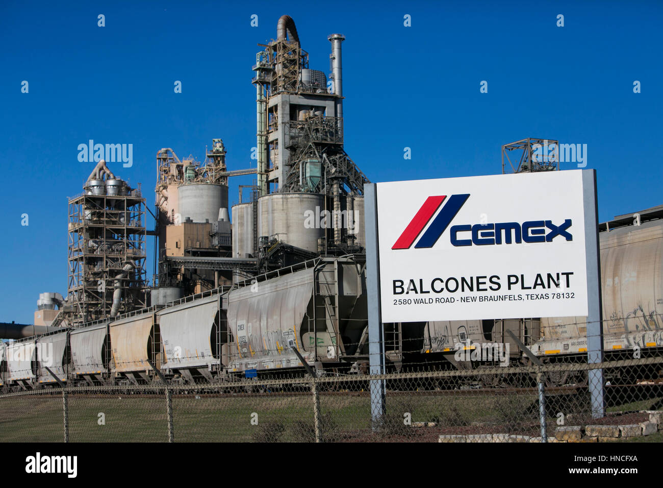 A logo sign outside of a facility occupied by Cemex in New Braunfels ...