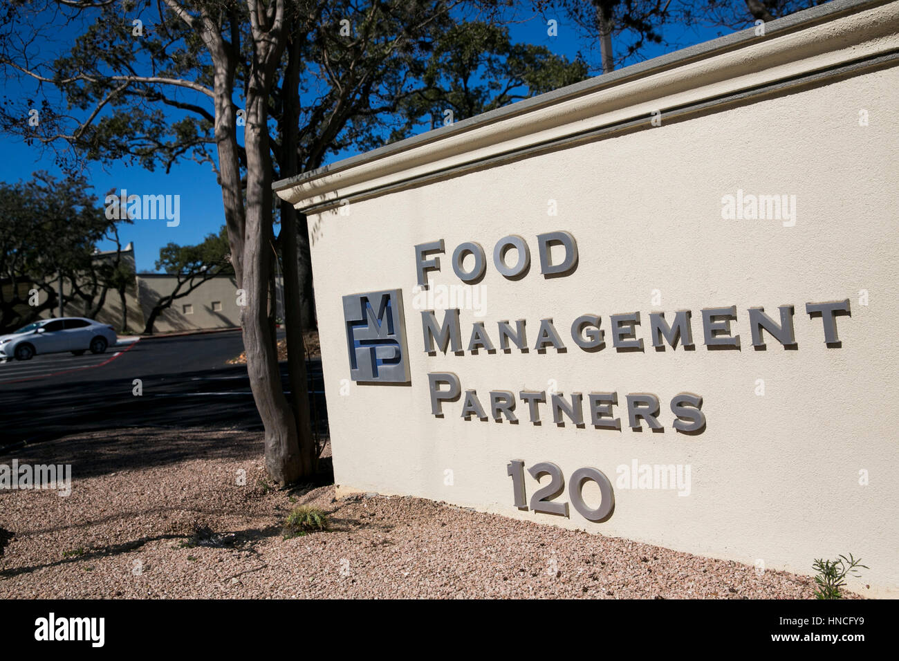 A logo sign outside of the headquarters of Food Management Partners in ...