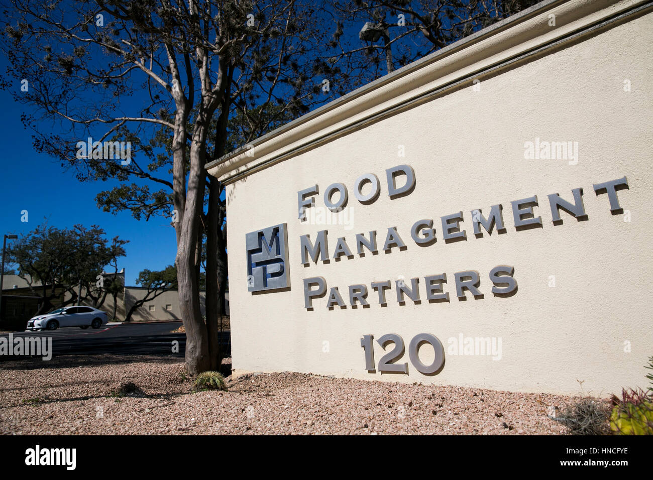 A logo sign outside of the headquarters of Food Management Partners in ...