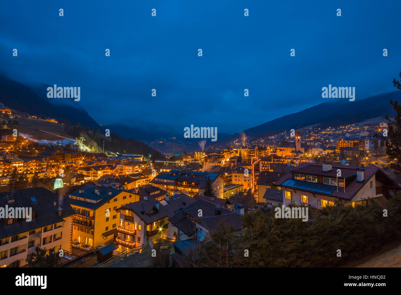 night view of typical mountain village in alpine valley in Italy Stock ...