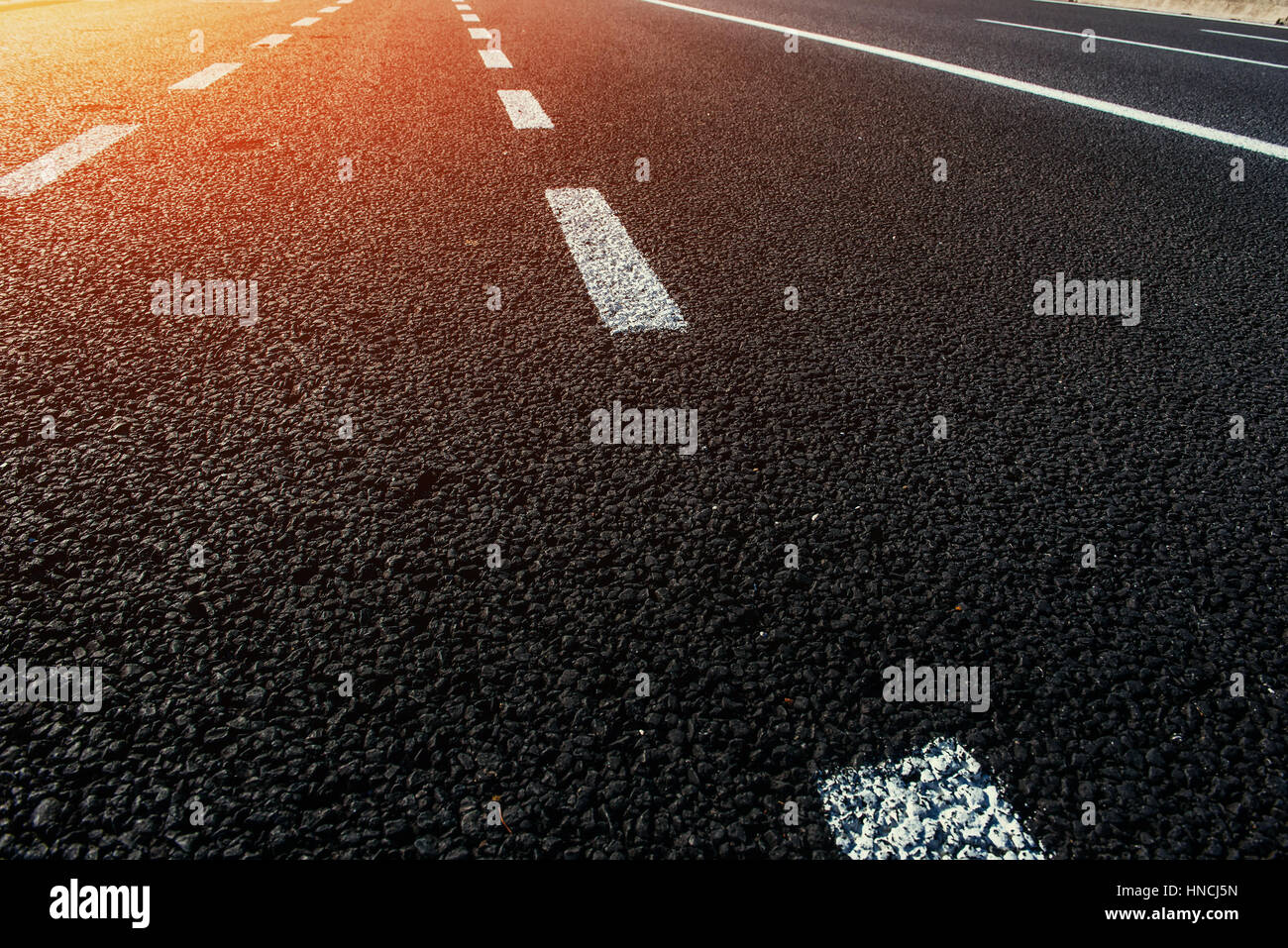 Asphalt Texture. New with white dashed line Stock Photo - Alamy