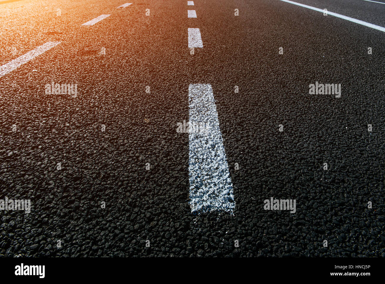Asphalt Texture. New with white dashed line Stock Photo - Alamy