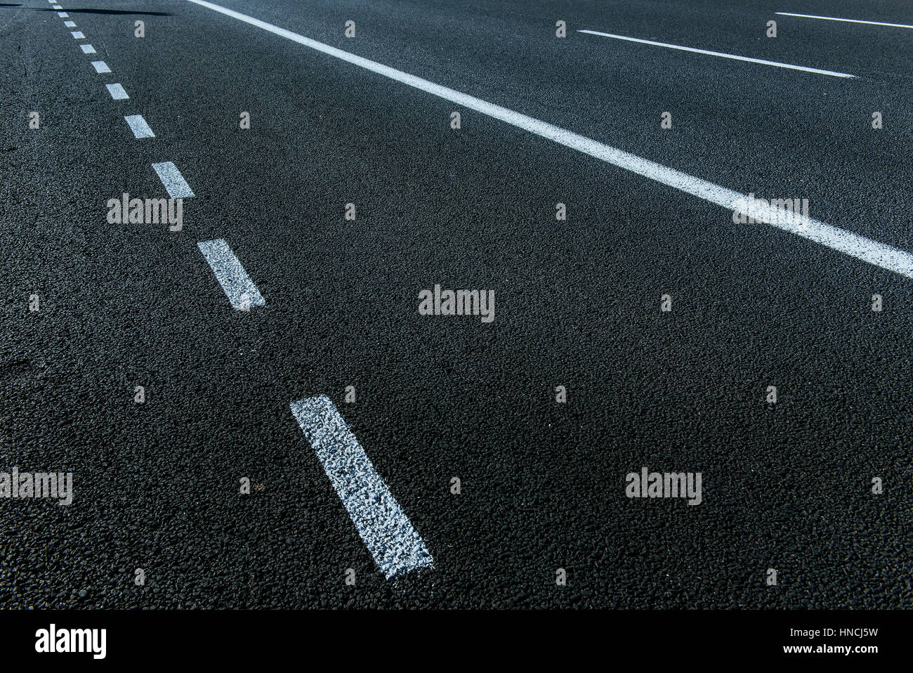 Asphalt Texture. New with white dashed line Stock Photo - Alamy