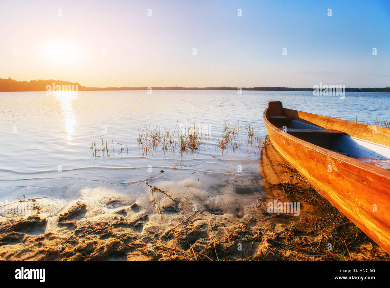boat on the lake at sunset Stock Photo - Alamy