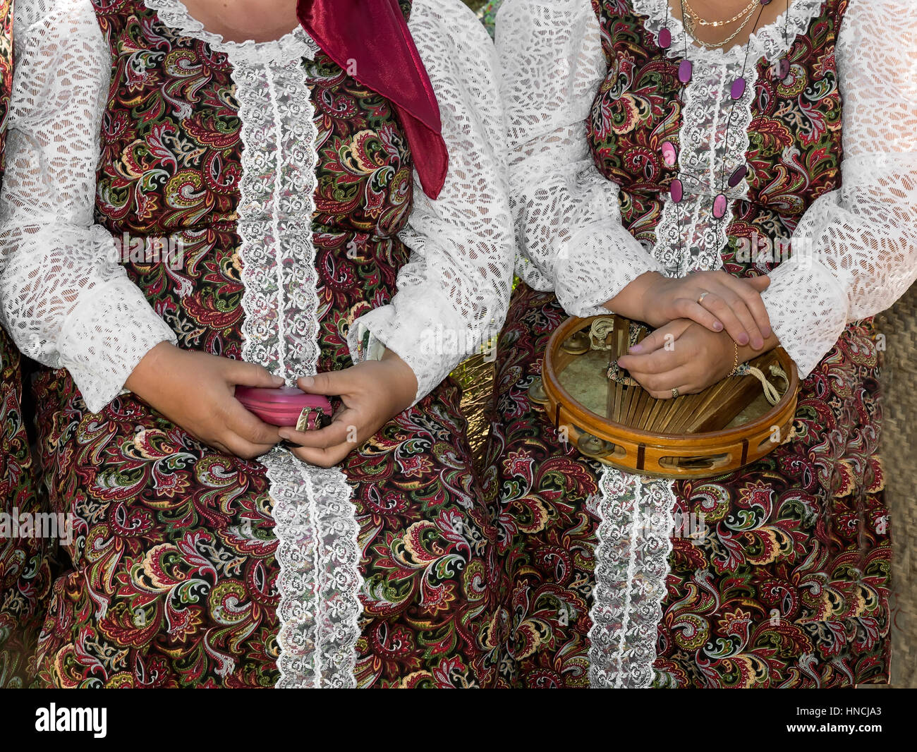 Two women in national costume holding musical instruments during a ...