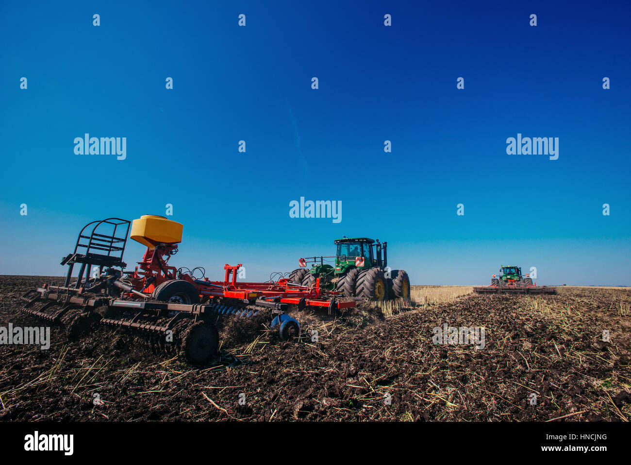 Tractor ploughing up the field Stock Photo - Alamy