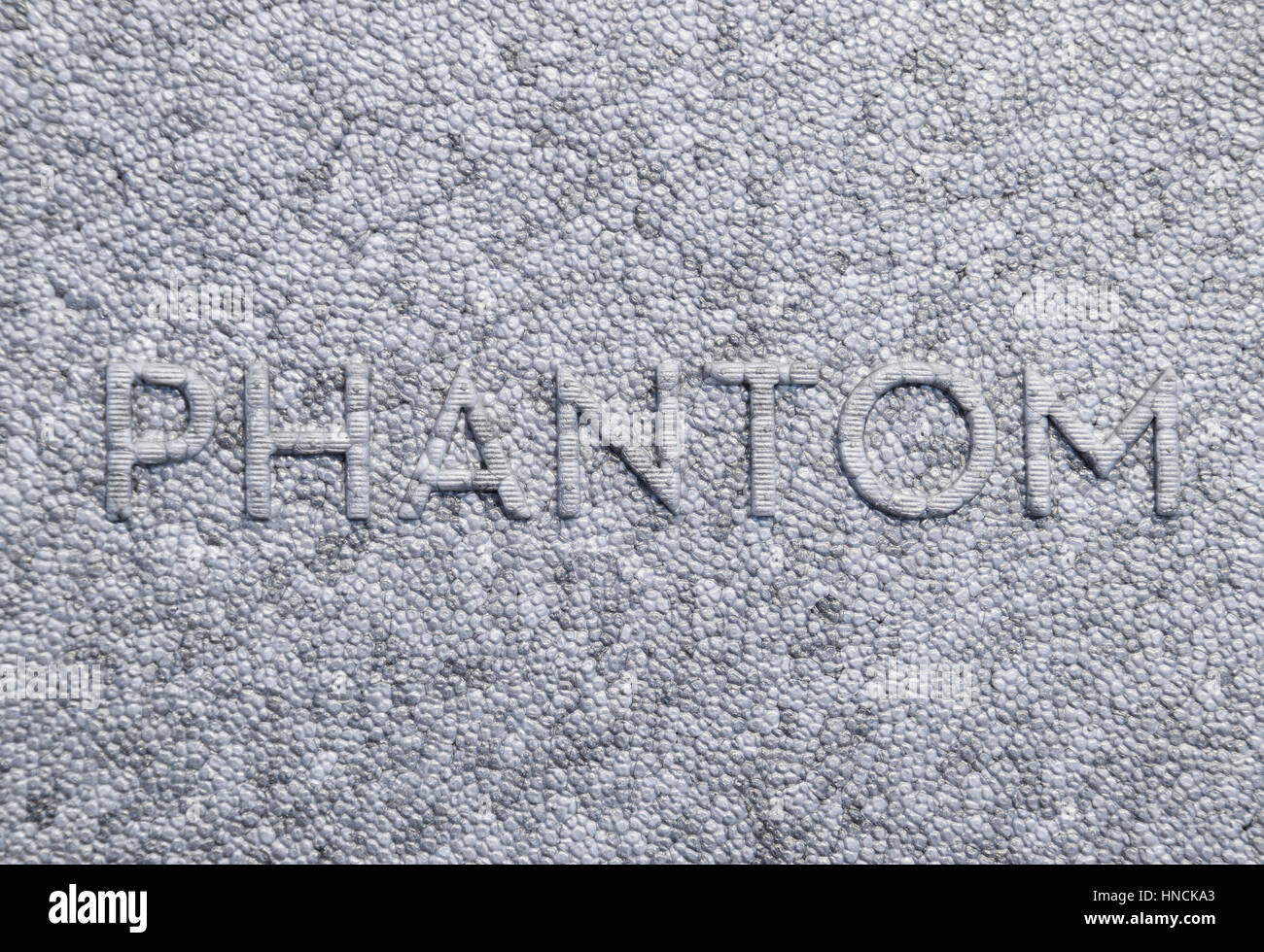 Word of the phantom on a gray foam. The pressed letter Stock Photo - Alamy