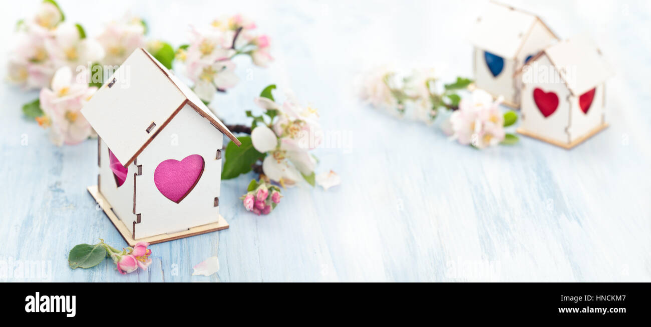 White Wood houses with colorful heart shaped windows Stock Photo - Alamy