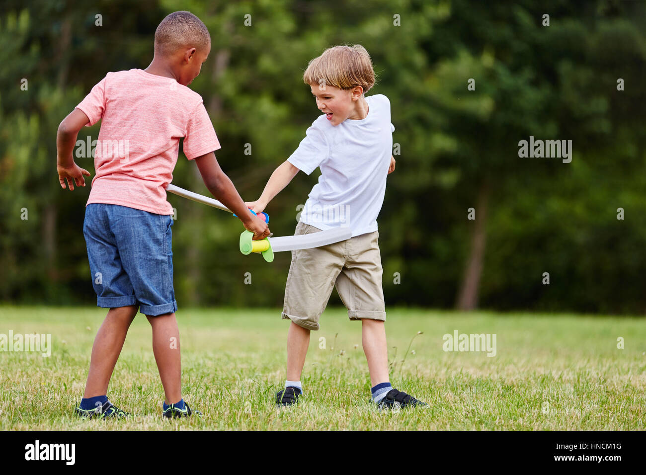 Kids play fighting sword fighting hi-res stock photography and images ...