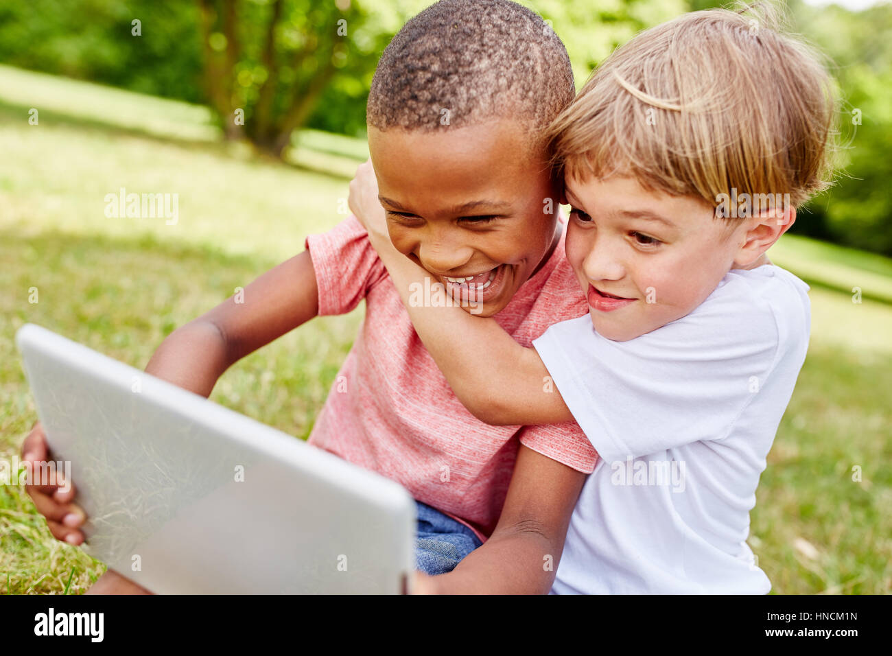 Children with laptop having fun and learning in summer Stock Photo - Alamy