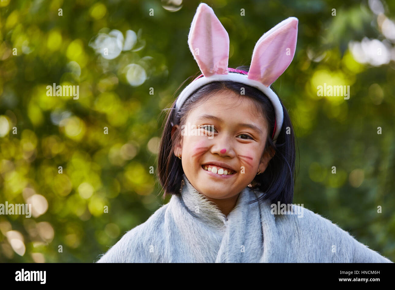 Girl dressed up like bunny with rabbit ears in carnival Stock Photo - Alamy