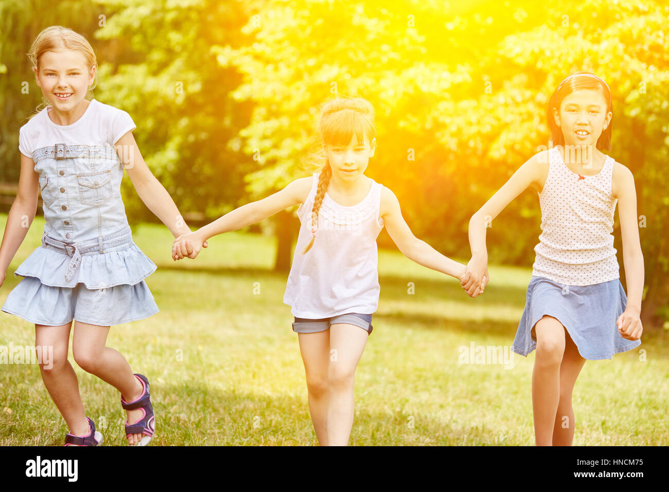 Group of girls walking together in the park in summer Stock Photo - Alamy